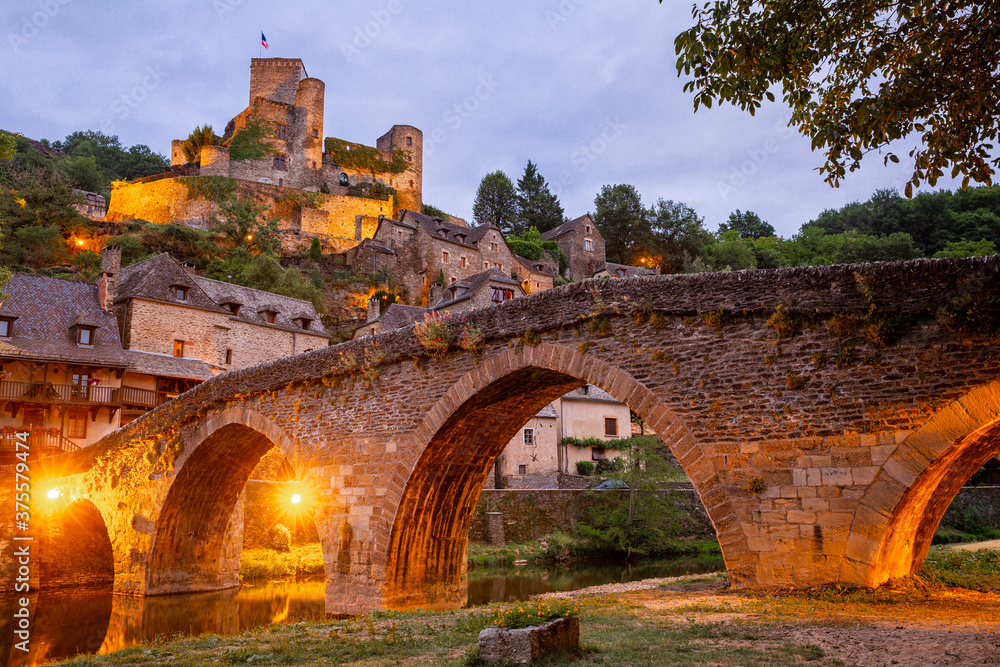 Medieval French Belcastel village with stone arched bridge across ...