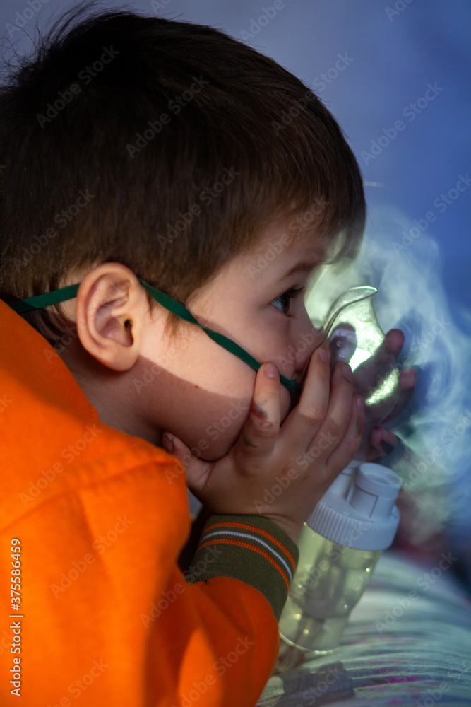 Little boy in a mask, treatments respiratory tract with a nebulizer at ...