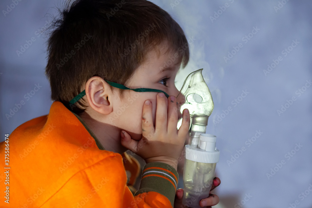 Little boy in a mask, treatments respiratory tract with a nebulizer at ...