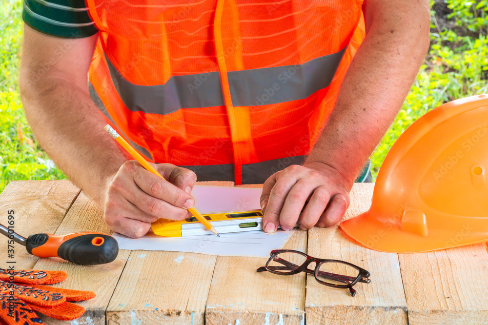 Master builder draws diagram with a pencil before planning work Stock ...