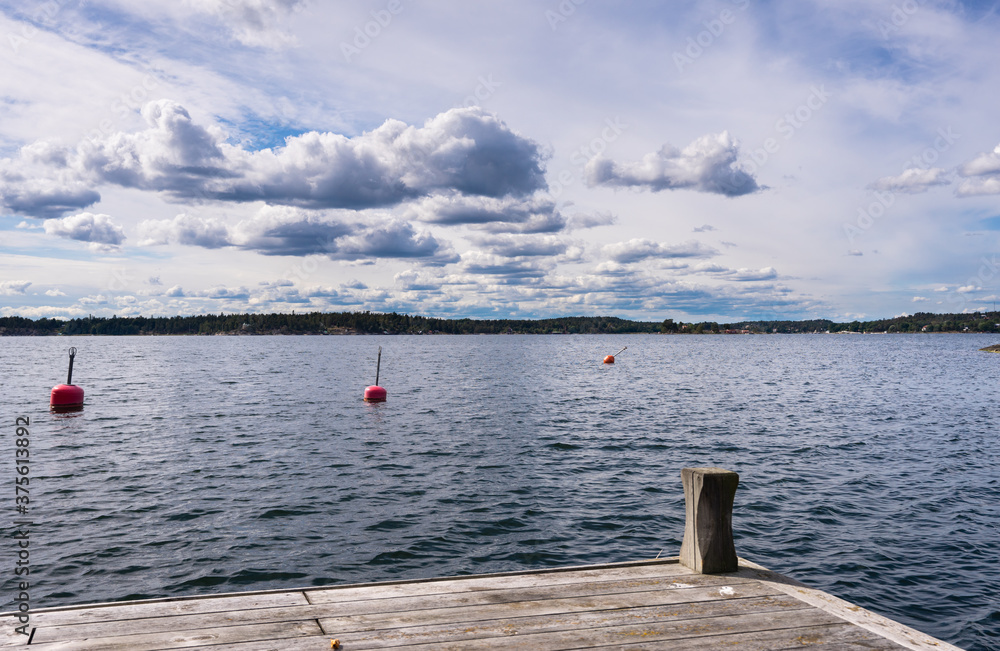 The corner of the wooden empty pier stretches out into the sea. Berth ...