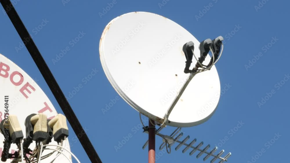 Satellite parabolic dish and signal receivers. TV antenna on wall of ...
