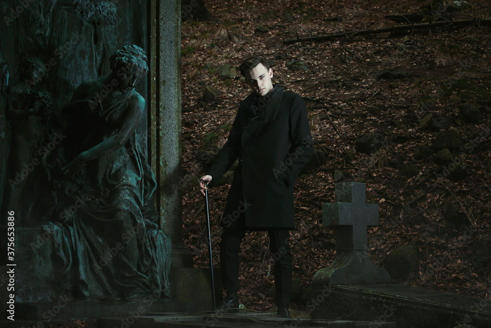Vampire and cemetery statue Stock Photo | Adobe Stock
