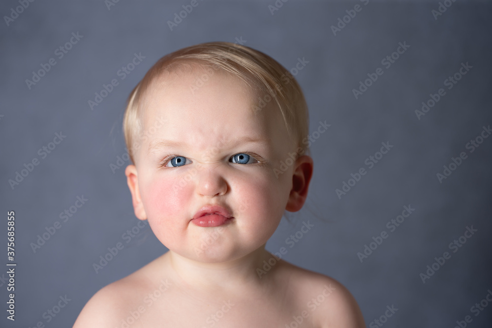 Fototapeta kuchenna Cute chubby pouting baby boy or girl toddler making ...
