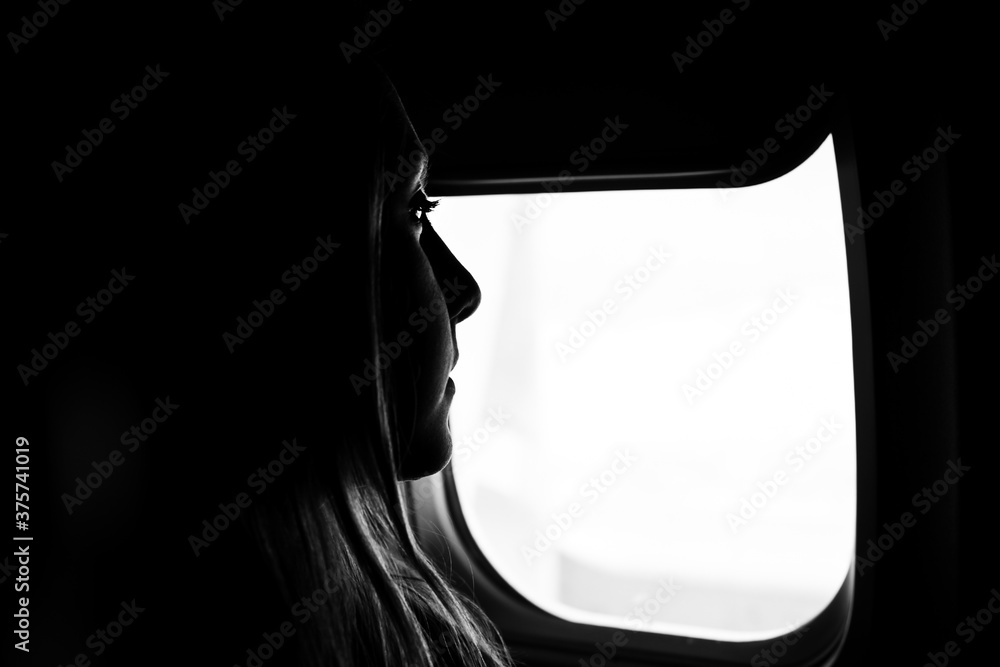 Little girl staring out the plane window Stock Photo | Adobe Stock