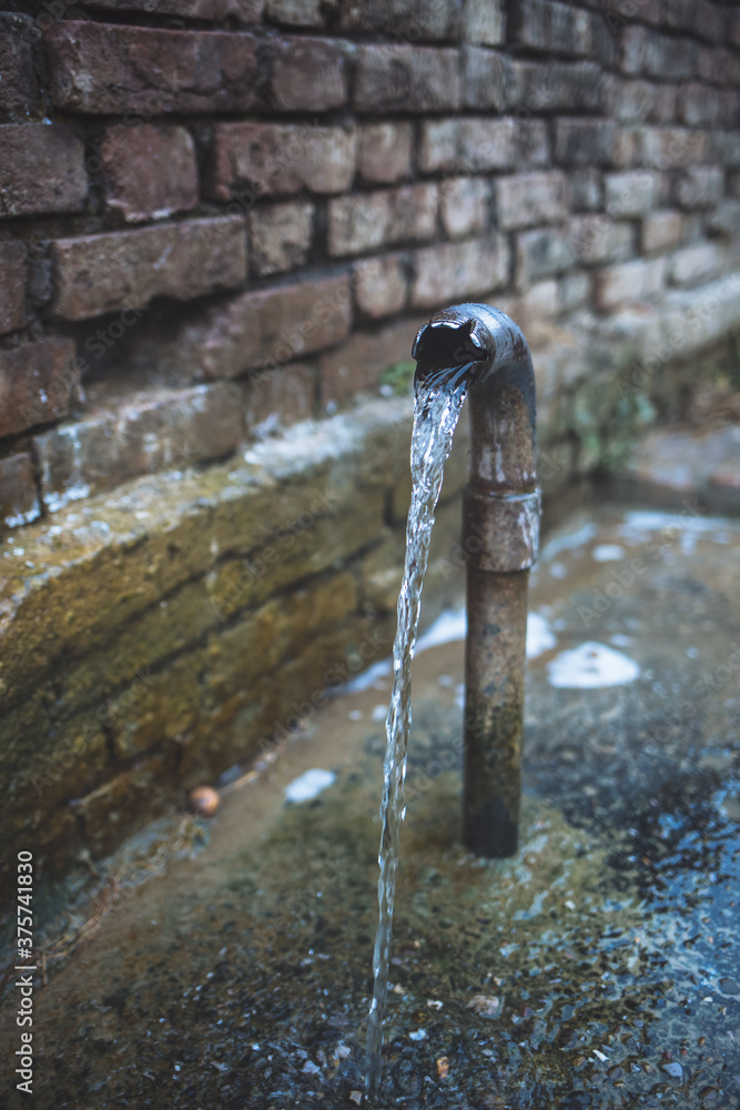 The water flowing out of the pipe Stock Photo | Adobe Stock