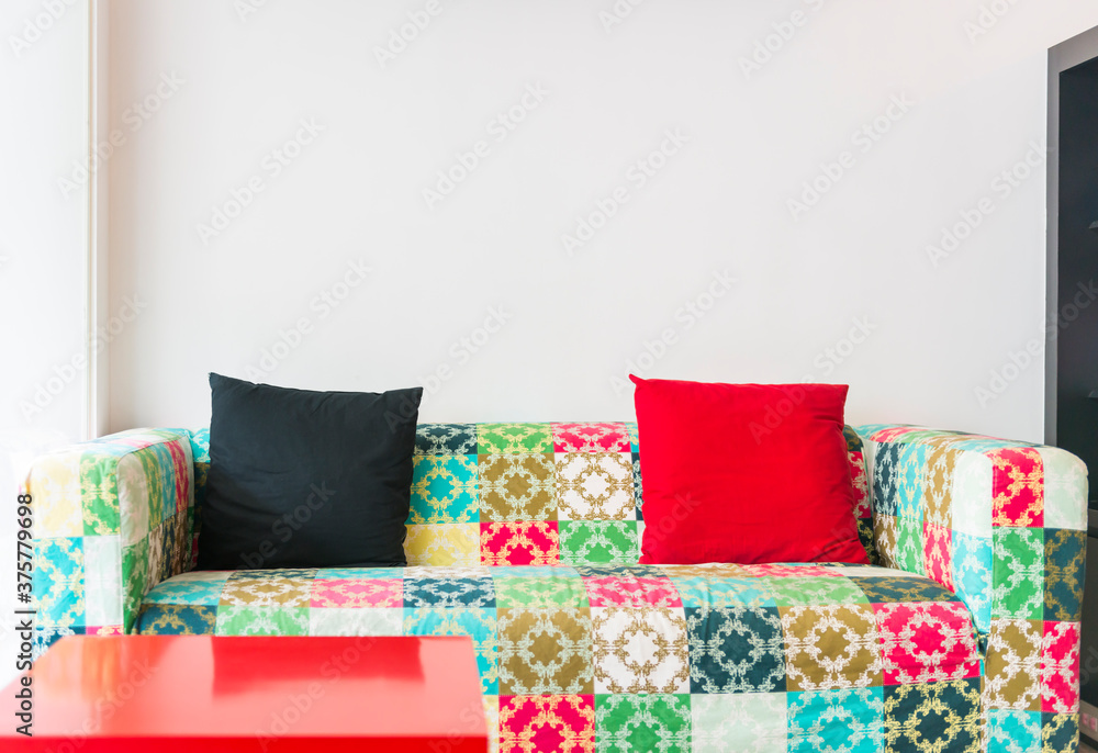 Colorful patchwork sofa with black and red cushions Stock Photo | Adobe ...