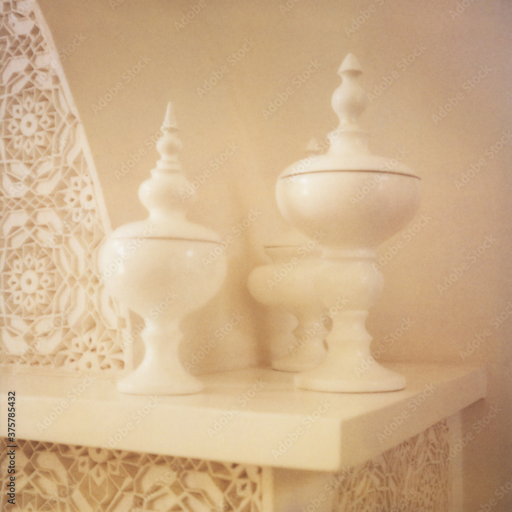 Three White Containers on a Decorative Shelf Stock Photo | Adobe Stock