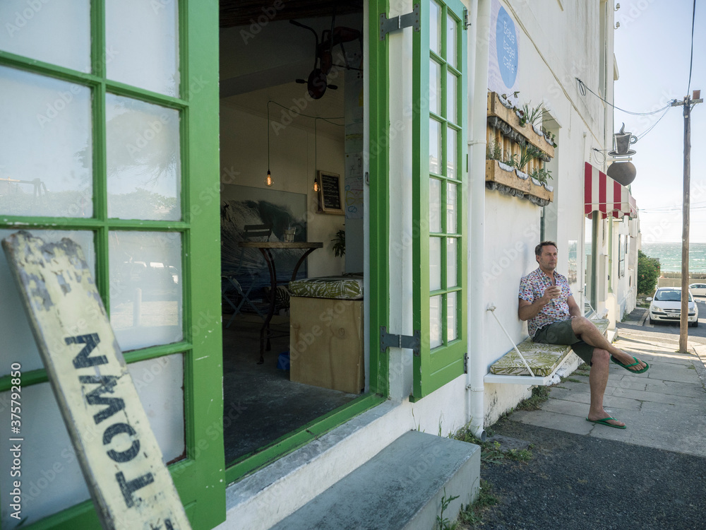 Surf Shack bagel and coffee shop owner/employee sitting outside Stock ...