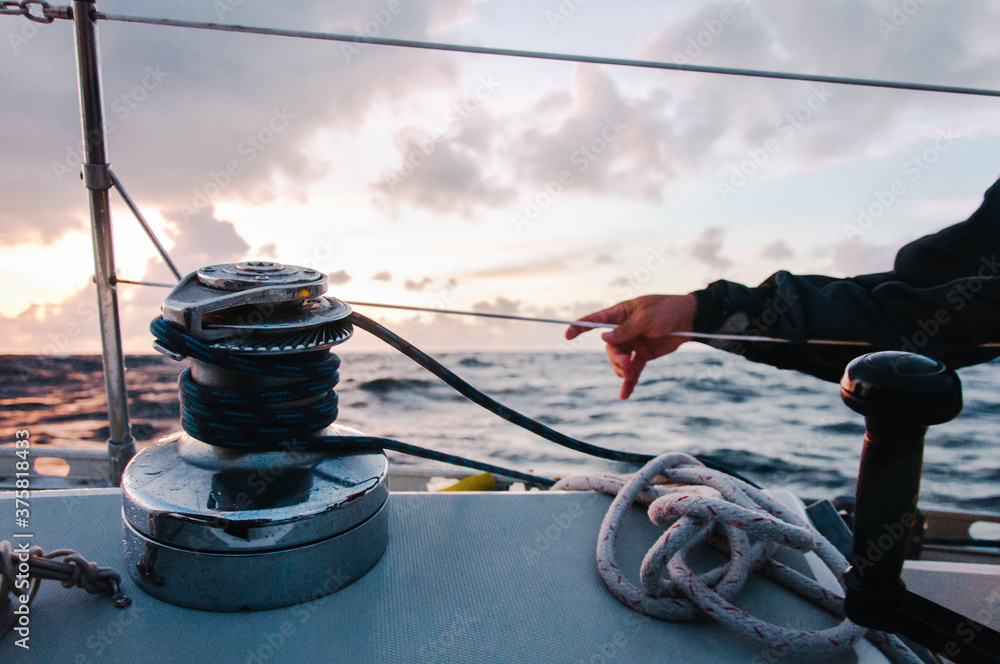 Hand on side of boat with sailing winch and boat line Stock Photo ...