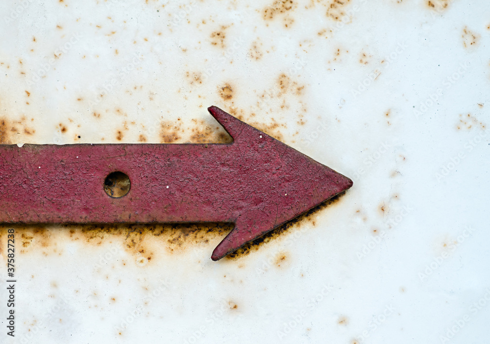 red metal arrow on a rusty white background Stock Photo | Adobe Stock