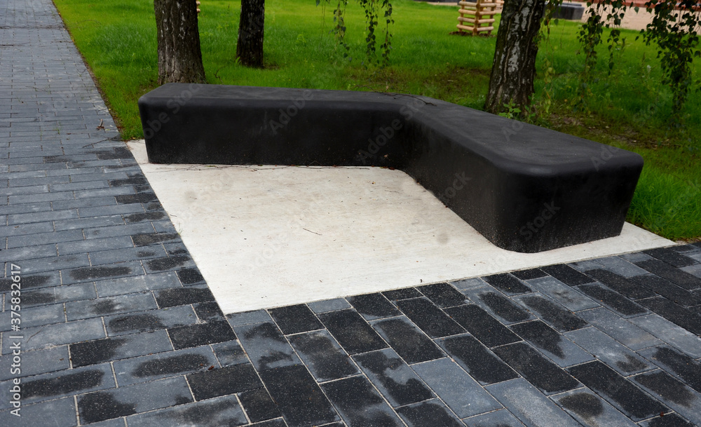gray monolithic concrete park bench made of concrete in the shape of ...