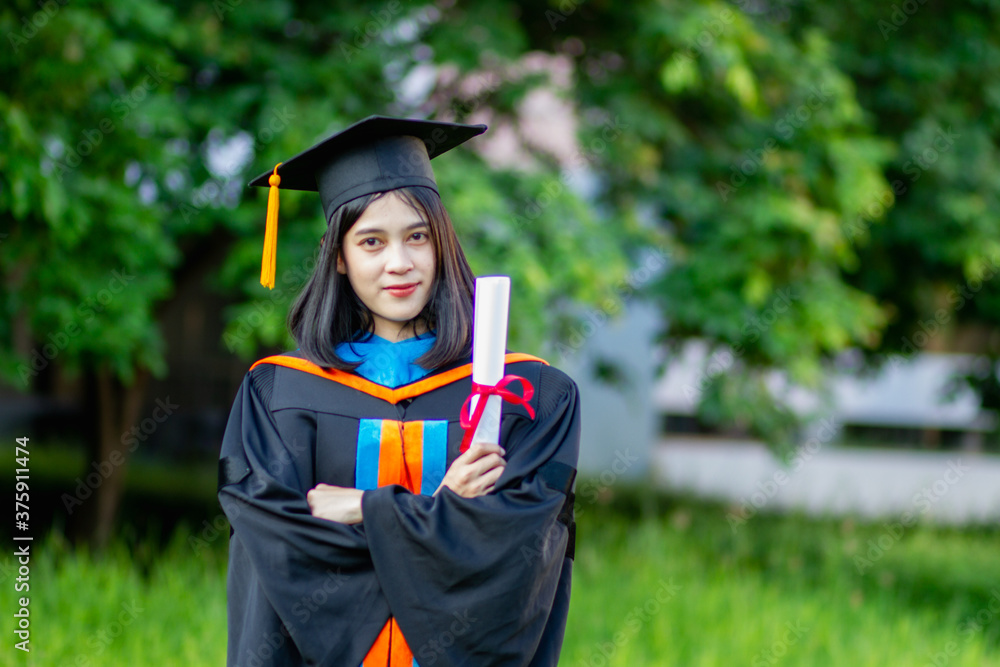 Graduation girl raises her hand to celebrate her graduation, complete ...