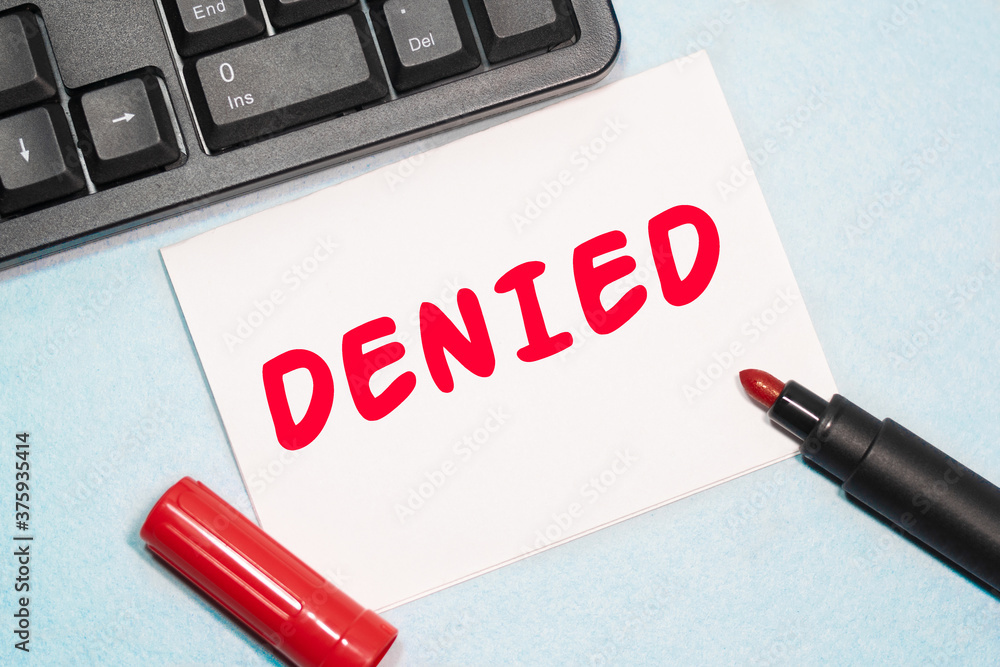 DENIED text on the business card written in red marker near the ...