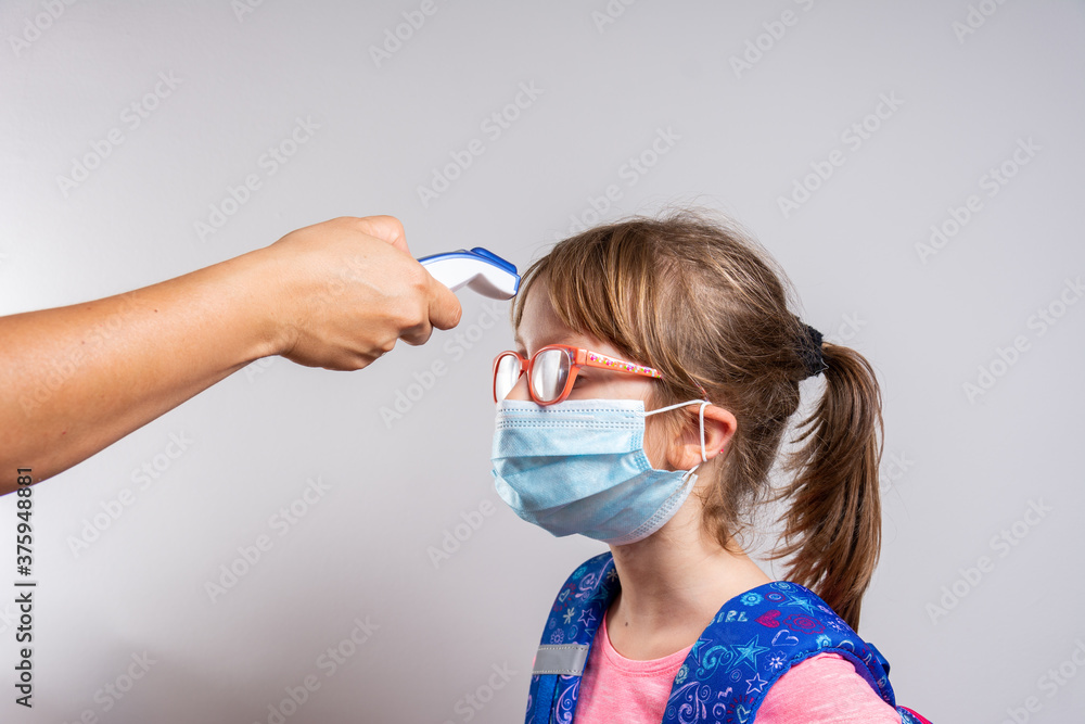 temperature check in school kid girl at school. Open school first ...
