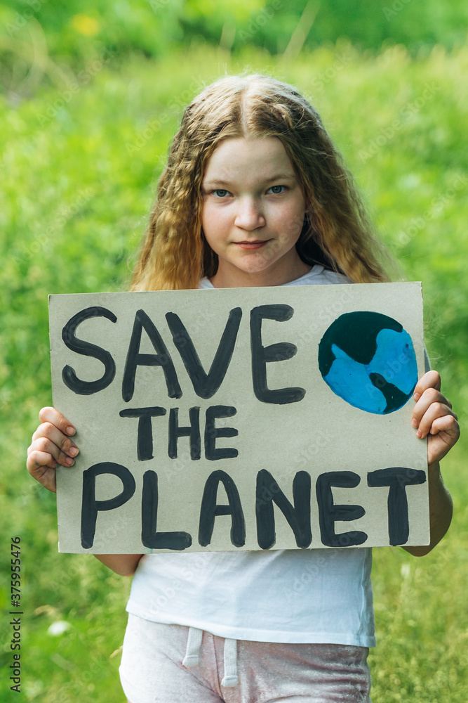 child girl activist with save the planet poster in forest park. preteen ...
