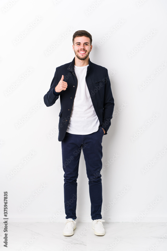 Full body young caucasian man isolated smiling and raising thumb up ...