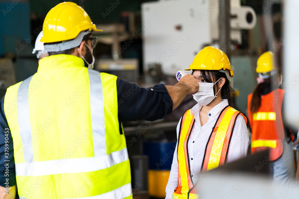 Temperature measurement with employee temperature meter before entering ...