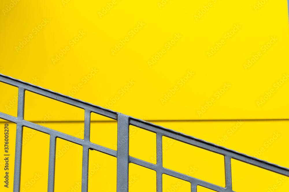 railing from the stairs on a yellow background minimalism in ...