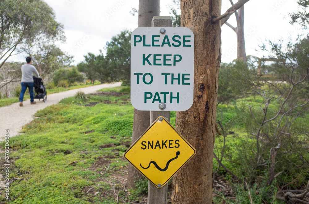 The sign of 'Please Keep to the Path' and the warning sign of snake ...