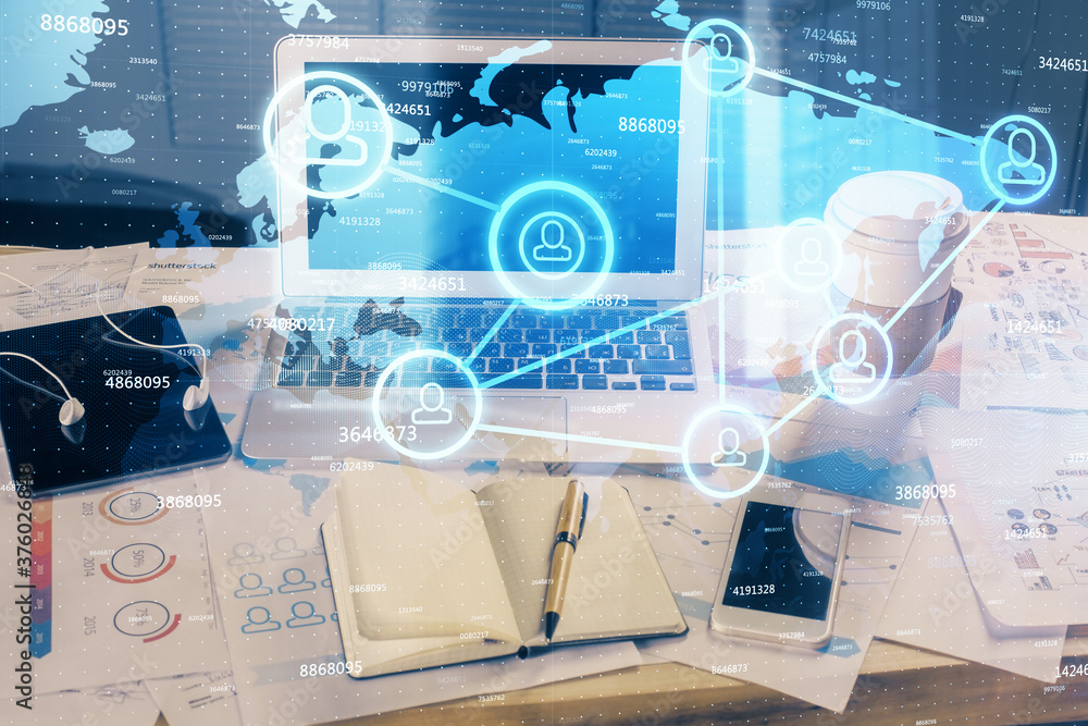 Computer on desktop with social network hologram. Multi exposure ...