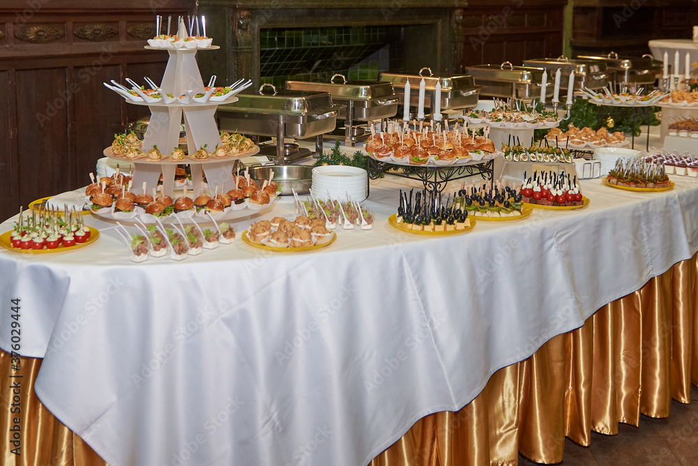 Buffet table with mini hamburgers, snacks, canape and appetizers at ...