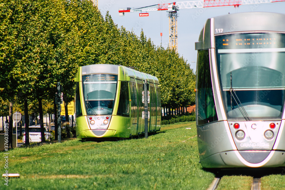 View of a modern electric tram for passengers driving through the ...