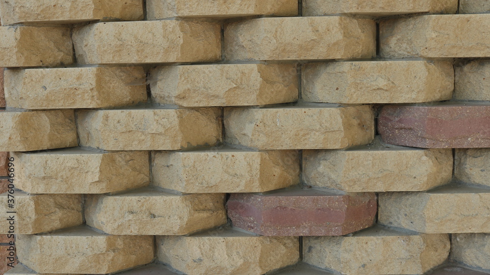 decorative brickwork with a volumetric texture of beige light brown ...