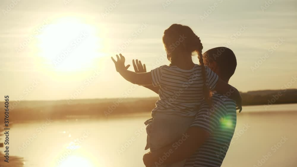 happy family dad and daughter by the sea at sunset silhouette. father ...