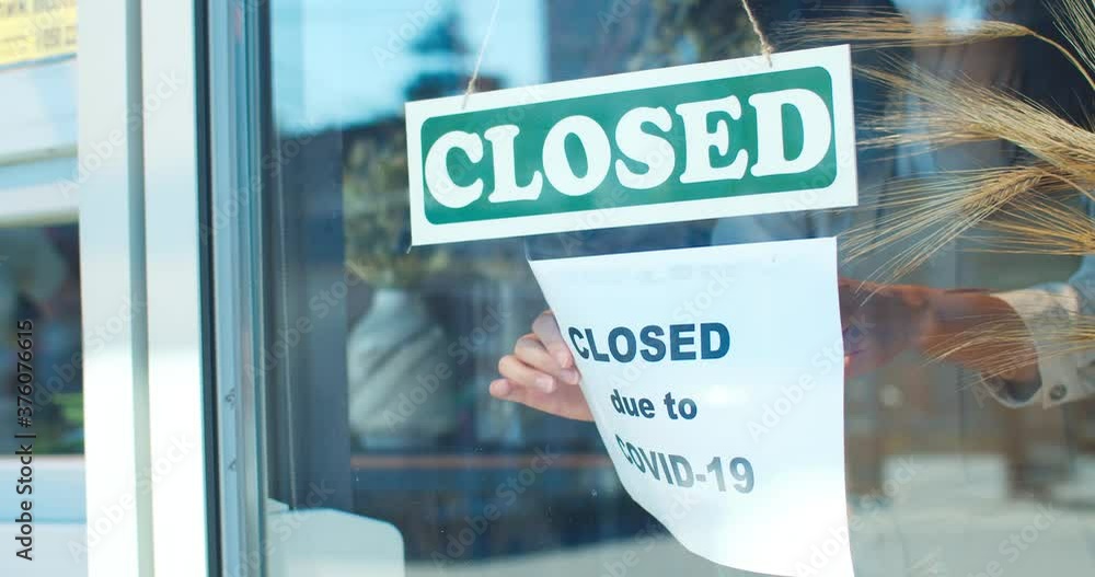 Outdoor view of window of florist store closed due to covid-19. Young ...