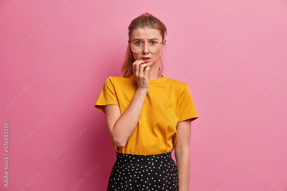Awkward European girl looks nervously, worried about stolen money ...
