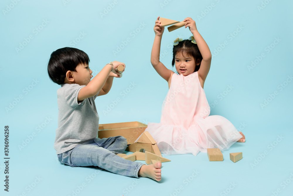 Asian two people kids playing together to be enjoyable with wooden toys ...