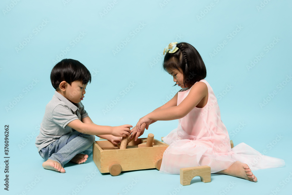Asian two people kids playing together to be enjoyable with wooden toys ...