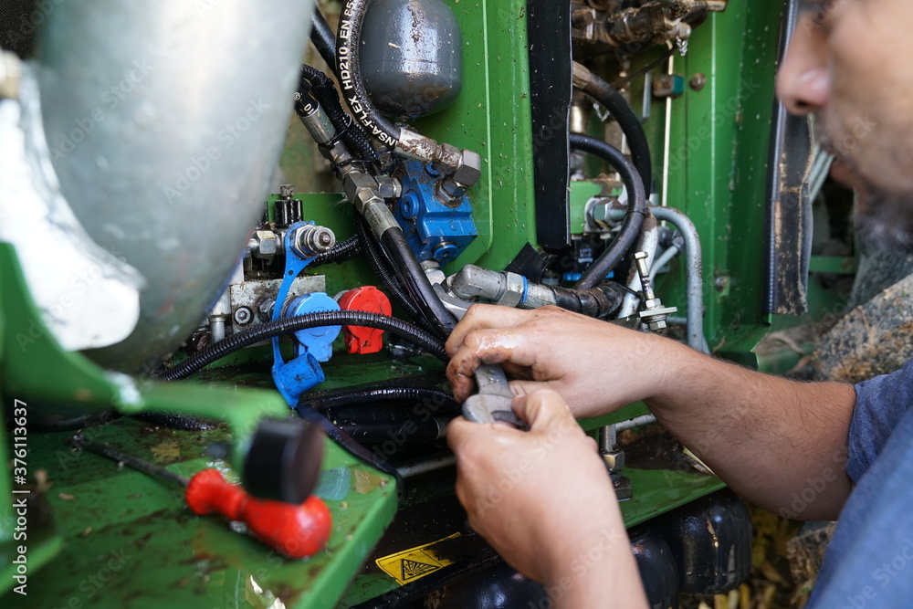 Combine harvester maintenance, repair of hydraulic systems by repairman ...