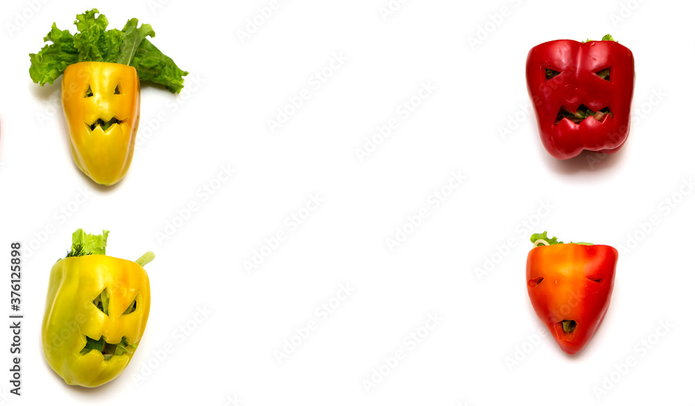 Multicolored stuffed peppers with various cutout faces in the skin on a ...