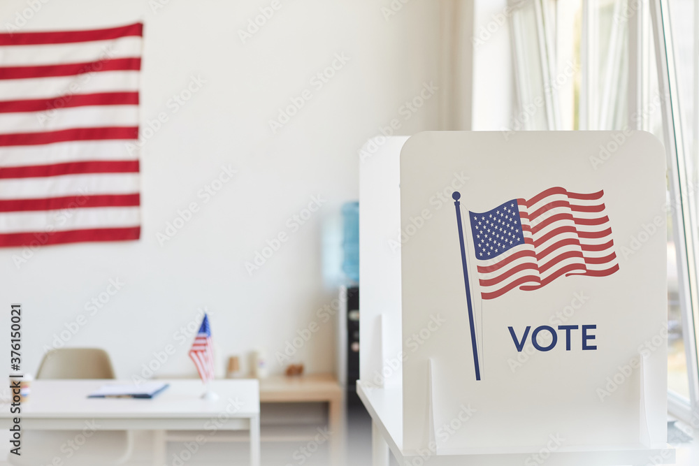 Background image of voting booths decorated with American flags at ...