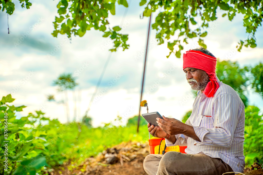 Indian farmer using mobile phone at Agriculture field Stock Photo ...