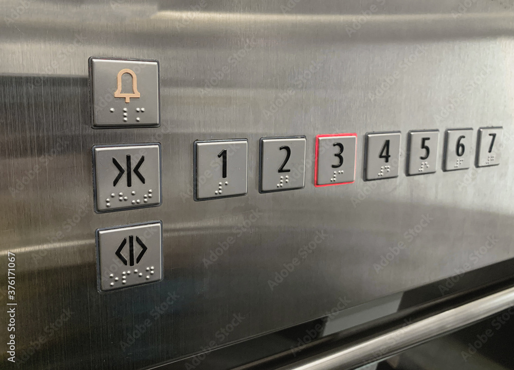 Close-up of the square floor button inside an office building elevator ...