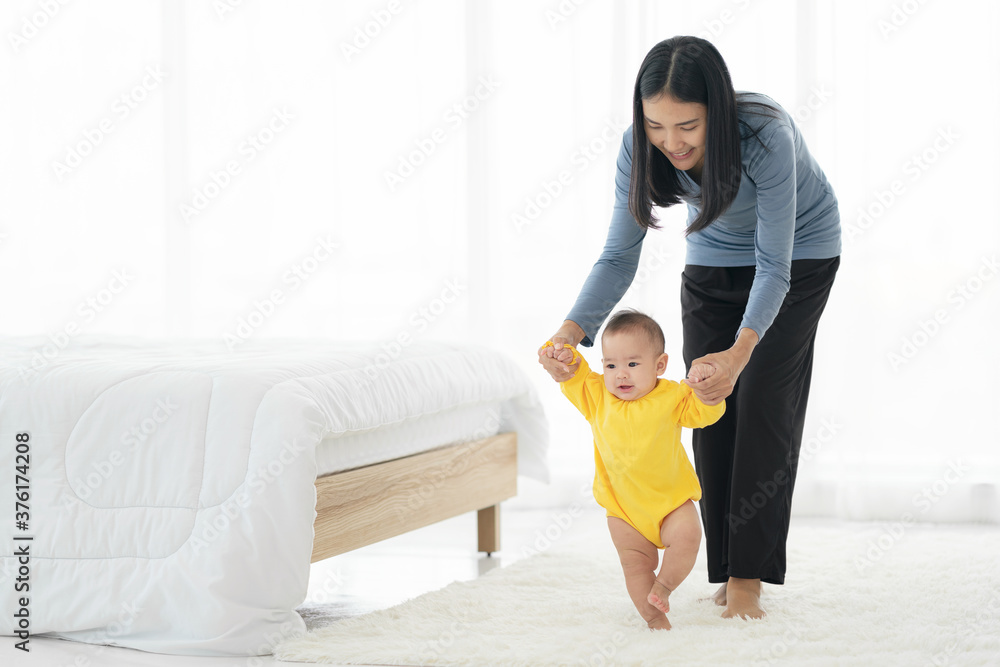 My little girl takes first steps. family happy little baby learning to ...