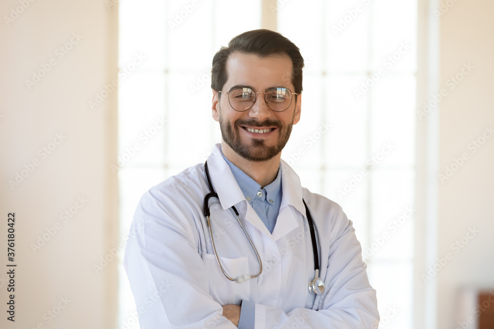 Head shot portrait smiling young man doctor wearing glasses and white ...