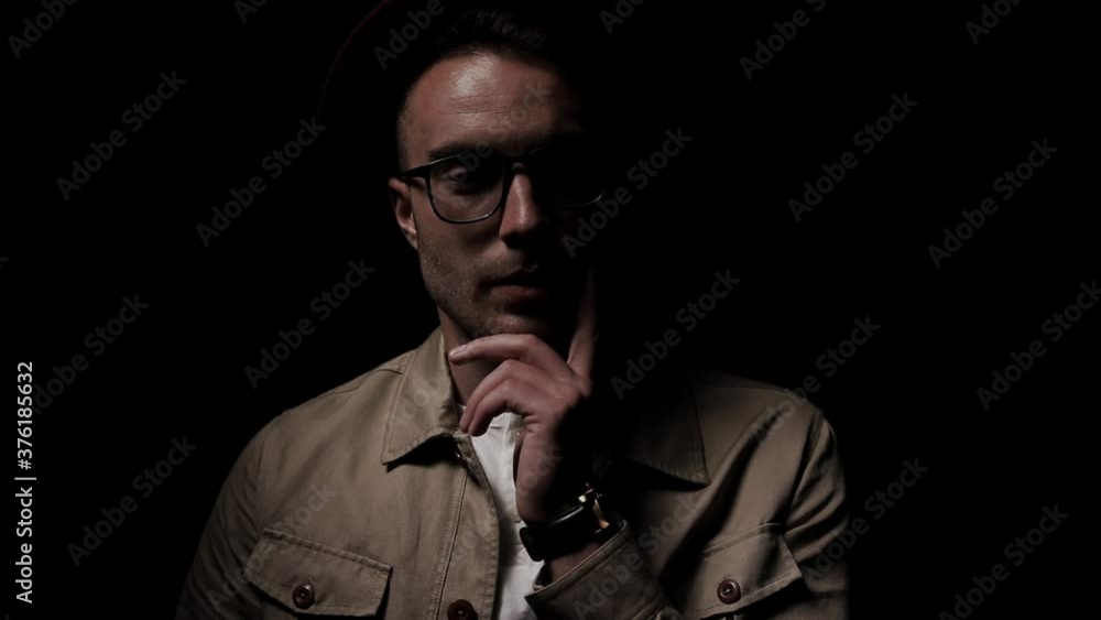 mysterious young model in beige jacket touching sensually chin and face ...