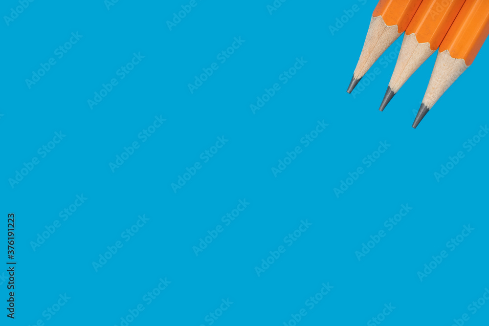 Blue school background with three yellow pencils Stock Photo | Adobe Stock