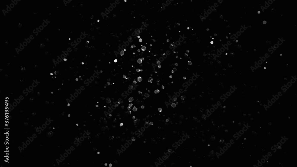 Close up of winter ice crystals particles flying in black space of ...