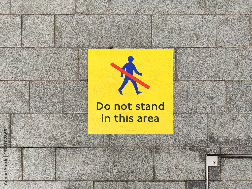 Bright yellow top-down view of do not stand here warning sign sticker ...