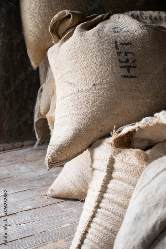 jute sack with grain inside a old mill. Rural traditional way of ...