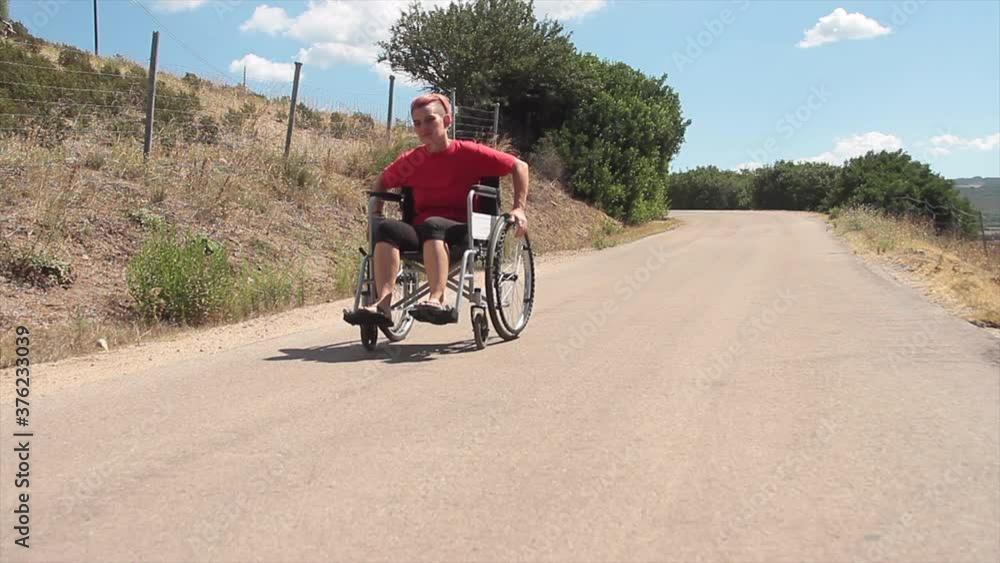 daily life of a disabled person in a wheelchair who travels a road ...