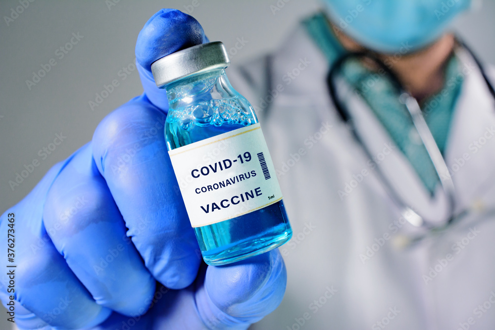 Doctor holds in hand a Coronavirus vaccine that is used for the ...