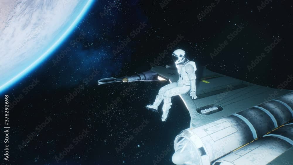 An astronaut sits on the wing of his spaceship and swings his legs ...