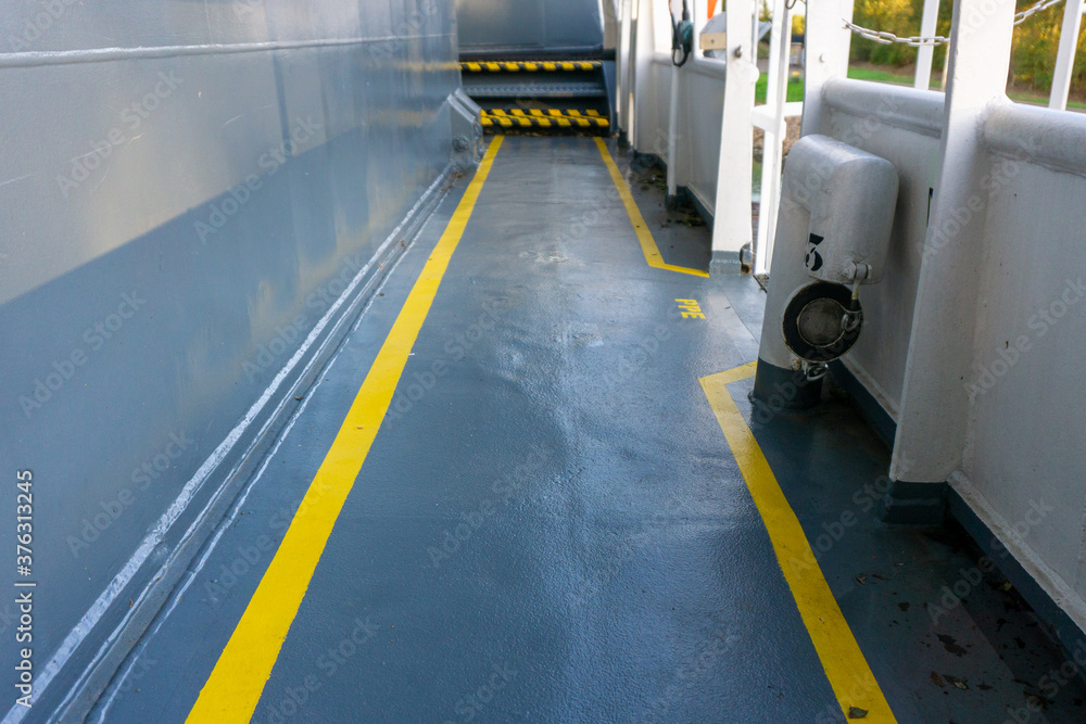 Safety walkway on ships deck. Yellow line walkway. Guided walkway on ...