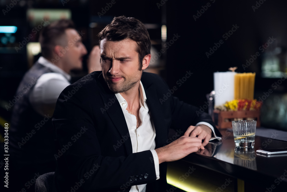 a young man drank a lot at the bar, sitting drunk at the bar with a ...